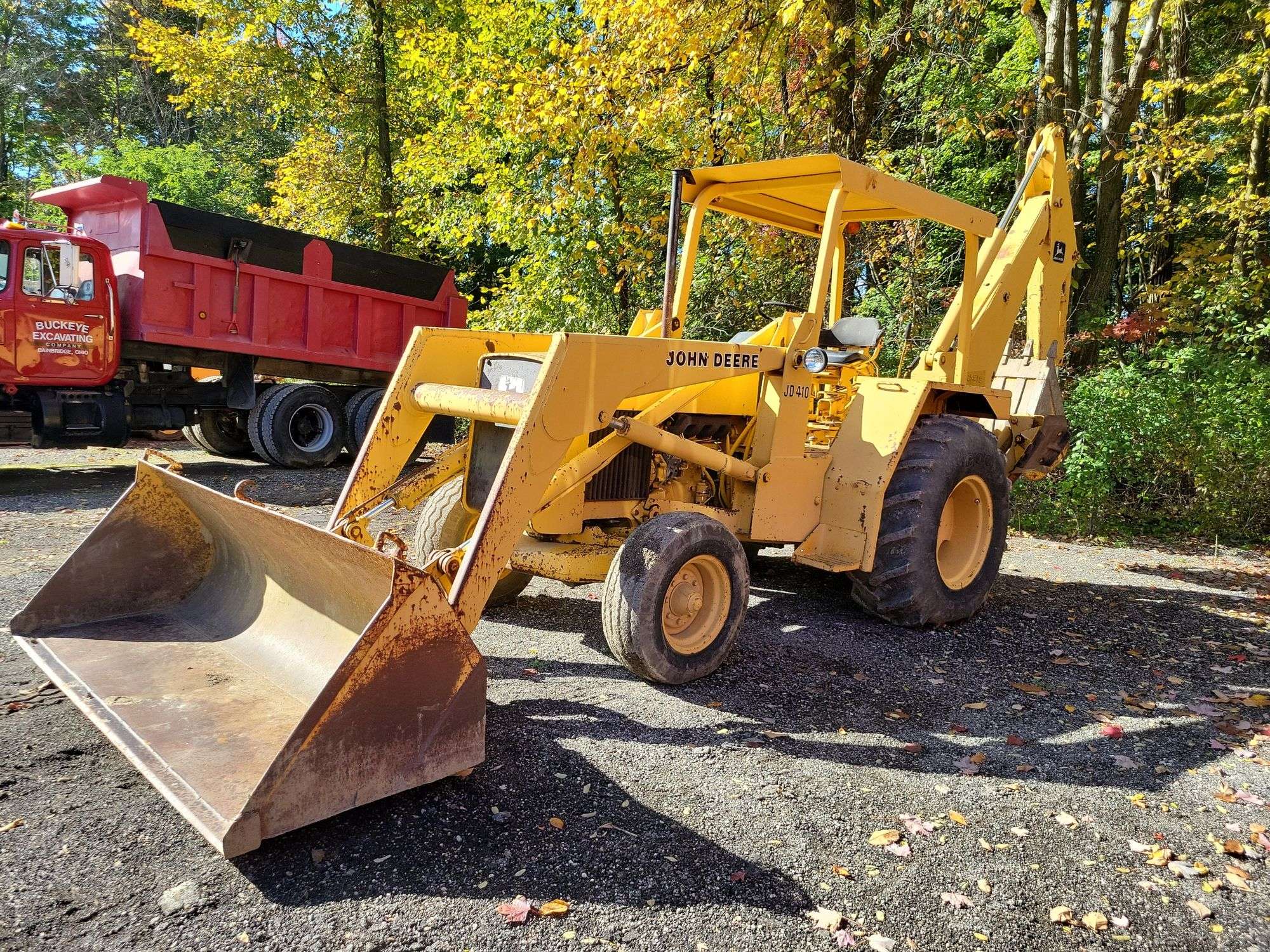 JD 410 backhoe showing 2,267 hrs - Kaufman Realty & Auctions