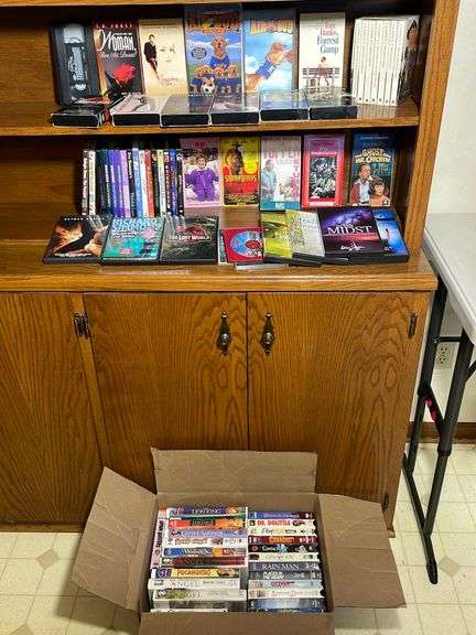 Large lot of VHS tapes, DVDs, and books - Kaufman Realty & Auctions
