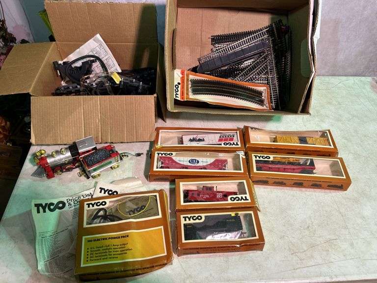 Box of train cars in boxes, railway, and other misc. train set parts ...