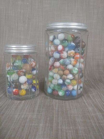 Two canister jars filled with marbles - Kaufman Realty & Auctions