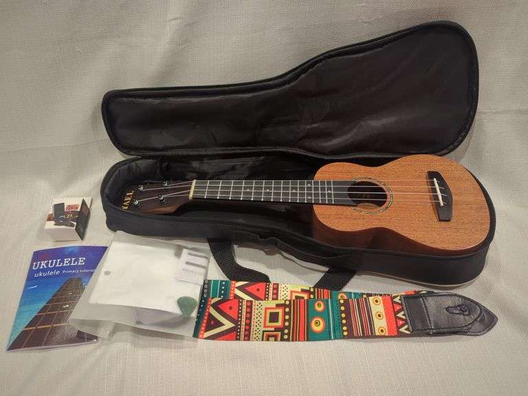 YAEL Ukulele with tuner and picks - works well - Kaufman Realty & Auctions