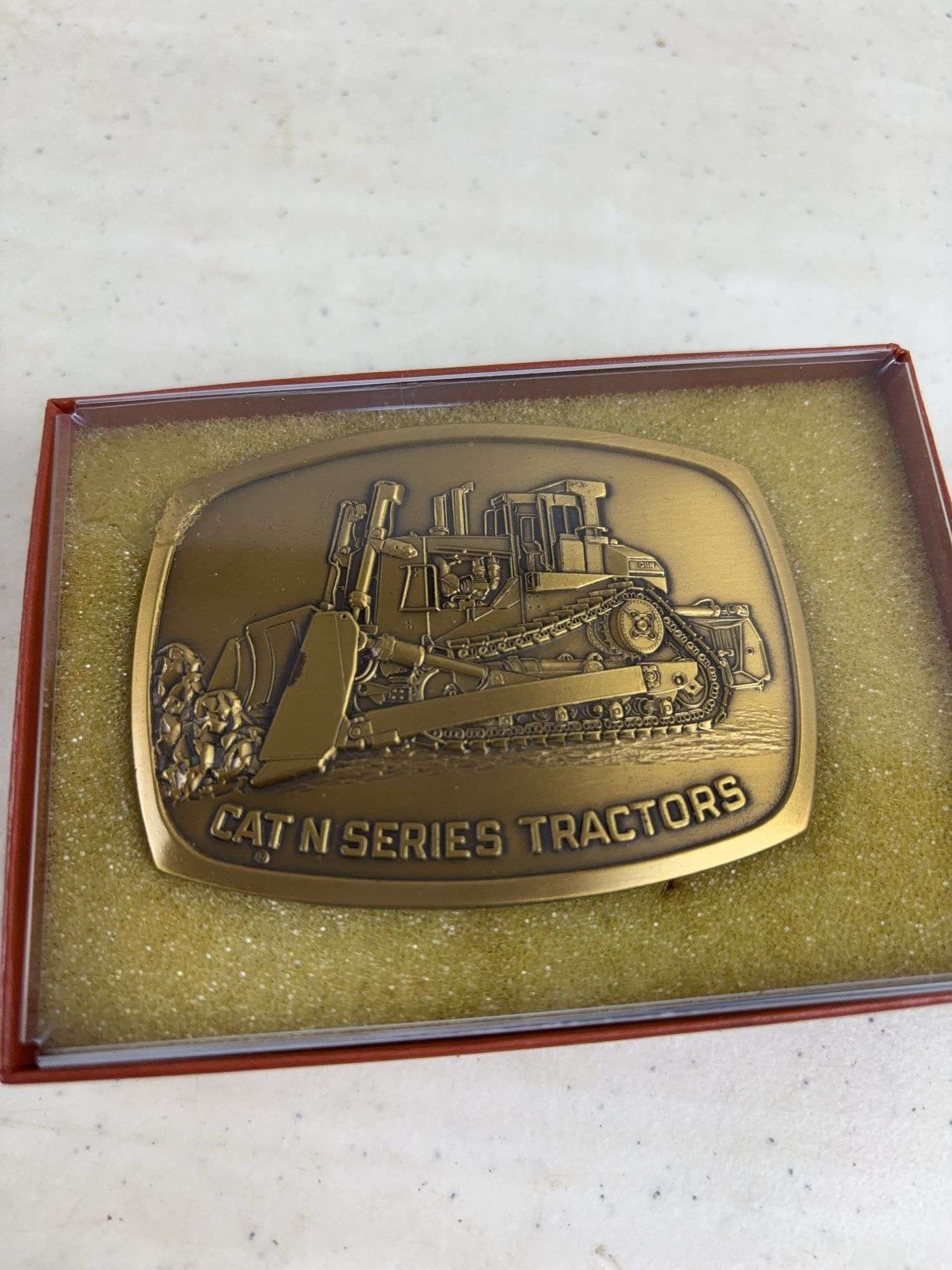 Caterpillar tractor belt buckle - Kaufman Realty & Auctions