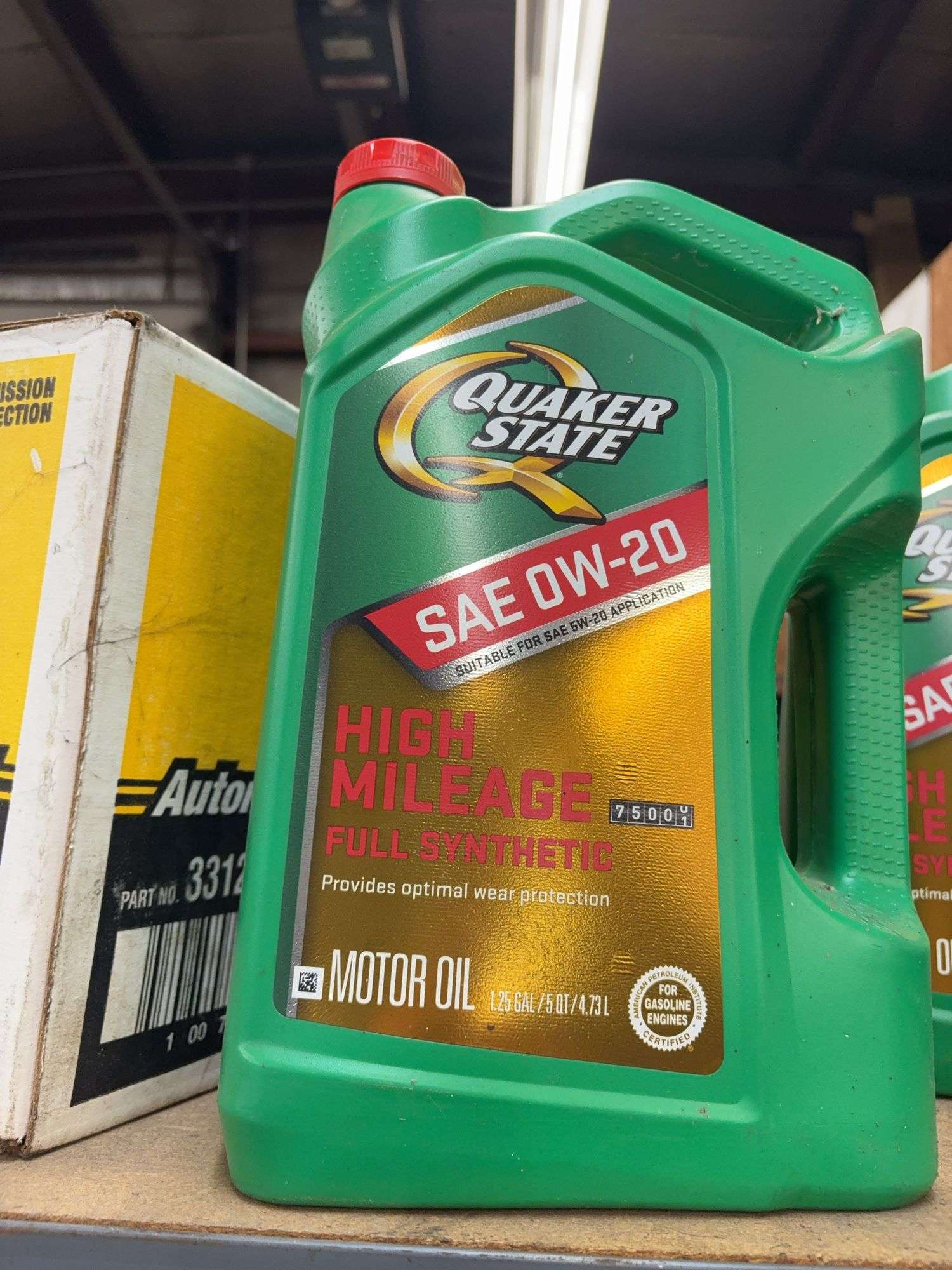 Contents of top shelf including Quaker State full synthetic oil, Mobil ...