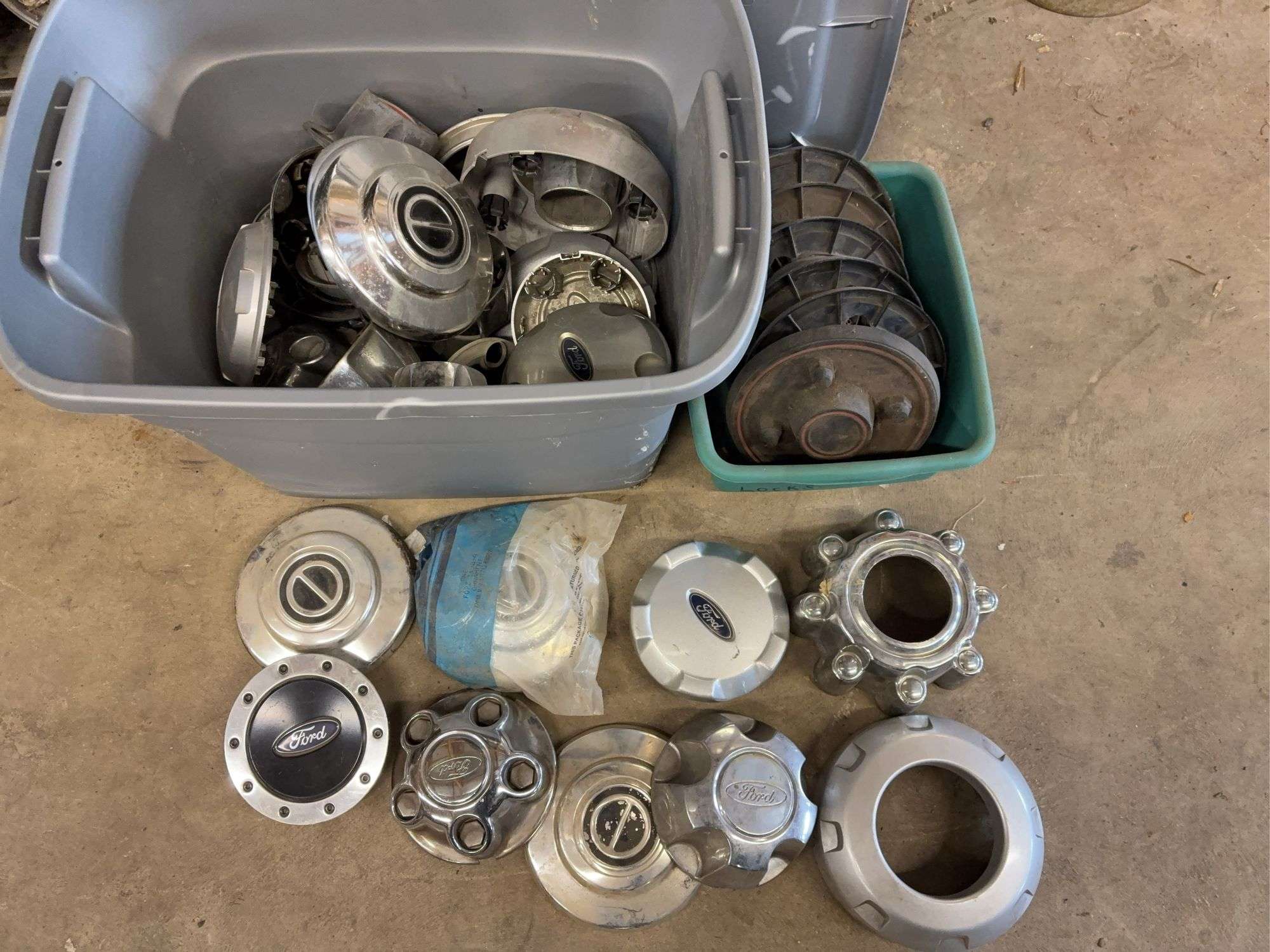 Tote of Ford hub caps and parts and small tote of Wheel cover locks ...