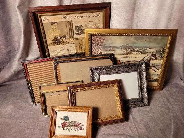 Asst’d picture frames and framed old Singer ad - Kaufman Realty & Auctions