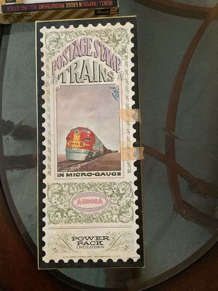 Postage stamp trains by Aurora. - Kaufman Realty & Auctions