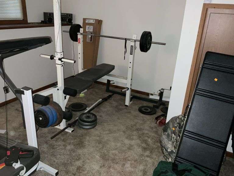 Pro 305 bench press with assorted weights - Kaufman Realty & Auctions