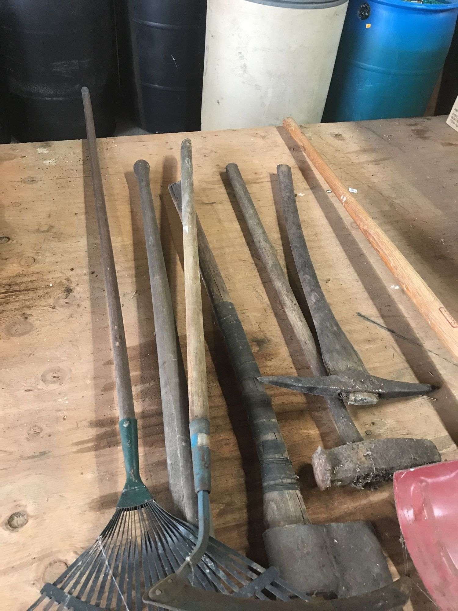 Antique long handled rake, shovel, brush cutter, hammer and pick ...