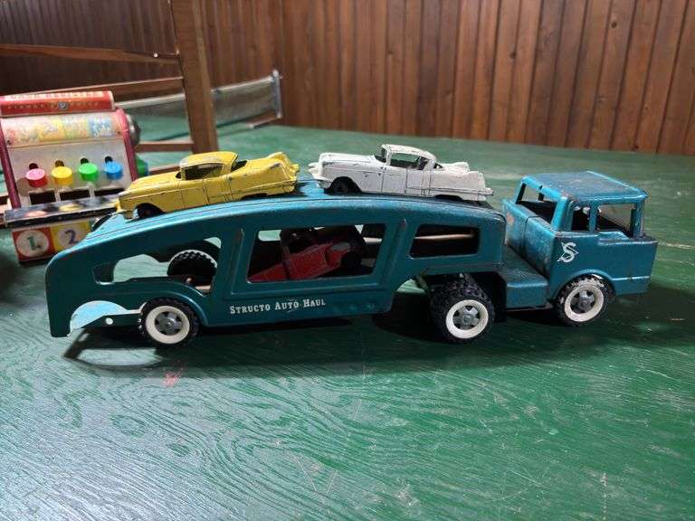 Structo car hauler with 3 cars - Kaufman Realty & Auctions