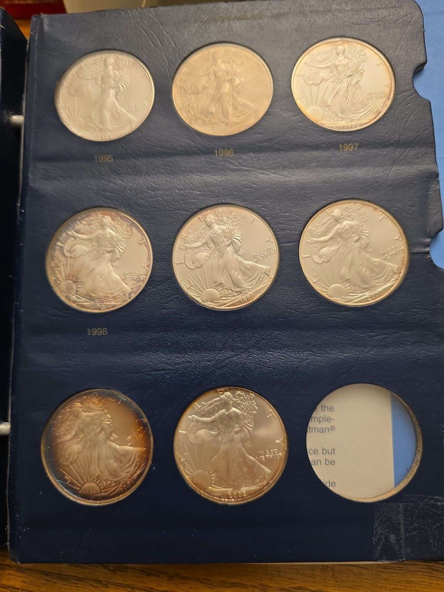 1986-2002 SILVER EAGLES IN ALBUM 17 COINS BU - Kaufman Realty & Auctions