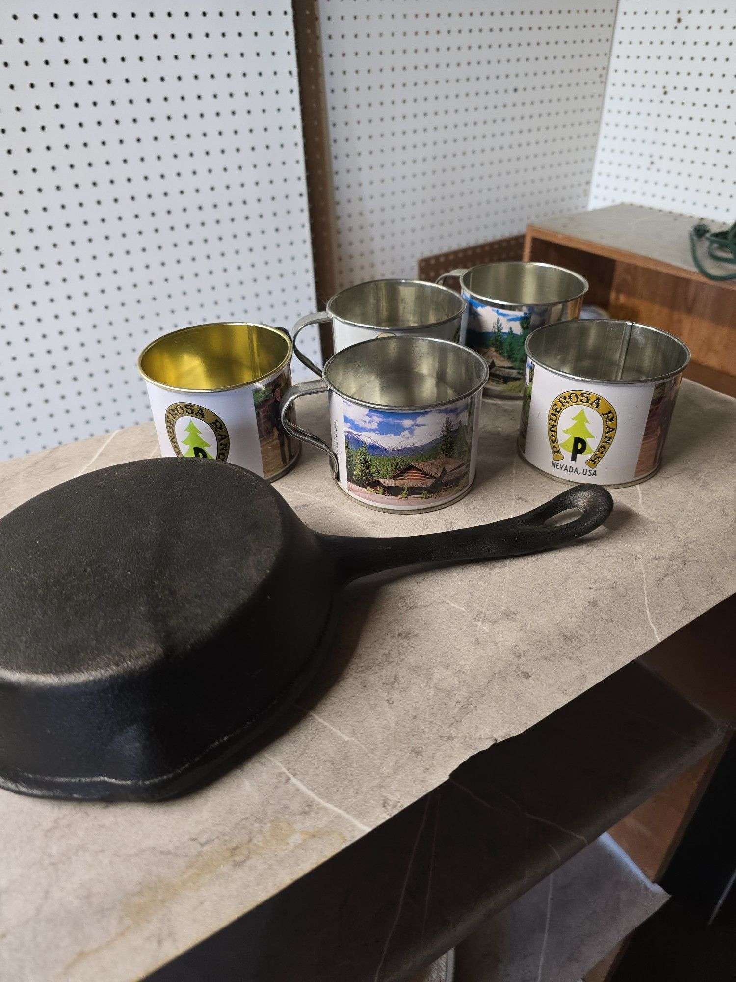 CAST IRON SKILLET AND ALUMINUM CUPS - Kaufman Realty & Auctions