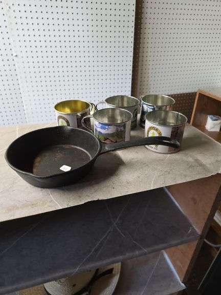 CAST IRON SKILLET AND ALUMINUM CUPS - Kaufman Realty & Auctions