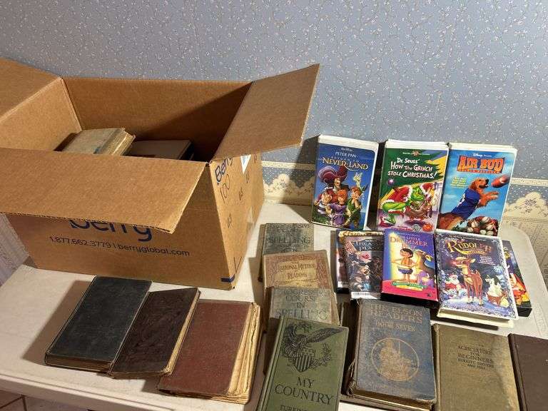 Assortment of books, VHS tapes, and DVDs - Kaufman Realty & Auctions