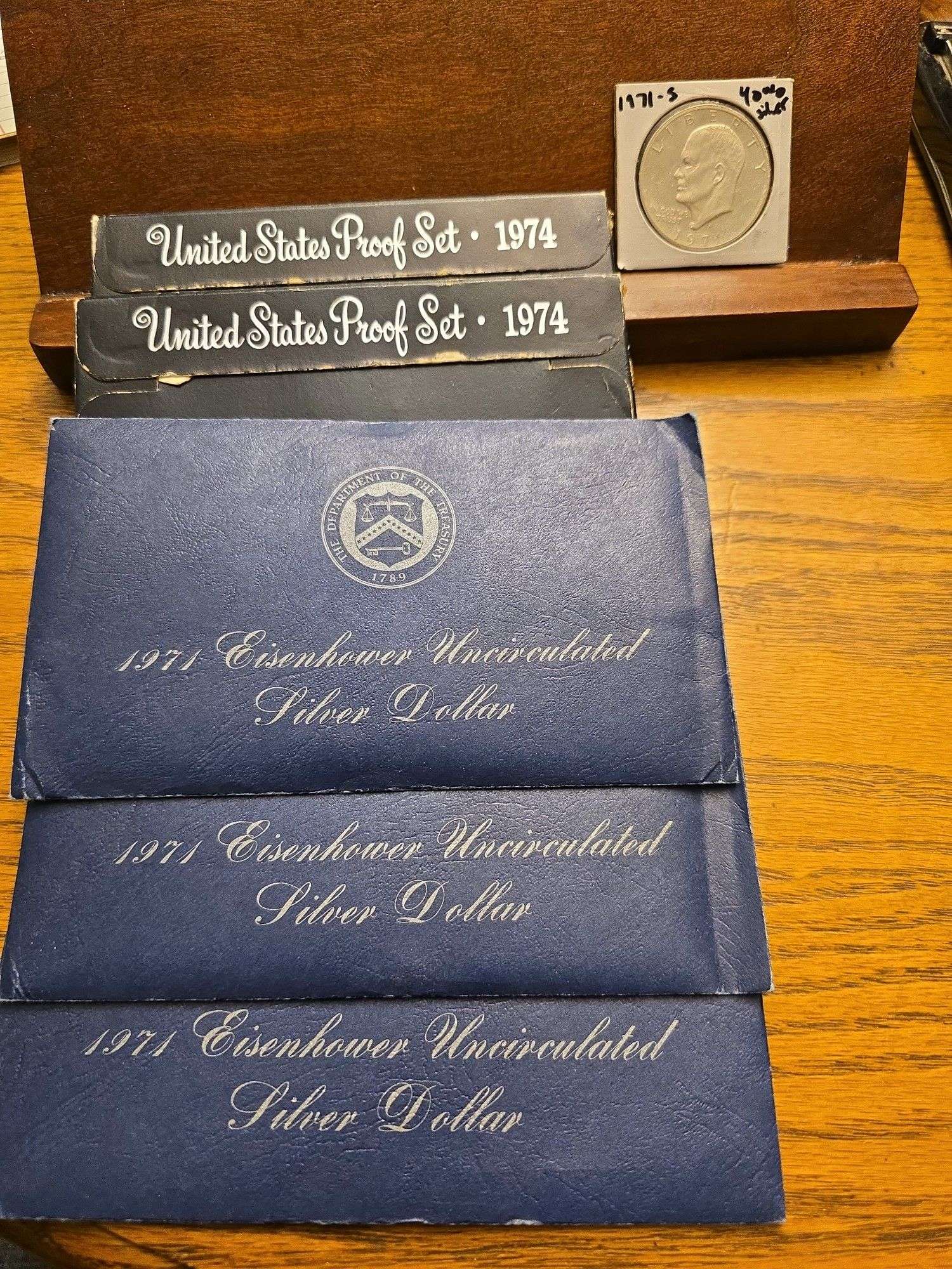 4-1971 SILVER IKE DOLLARS AND 2-1974 PROOF SETS - Kaufman Realty & Auctions