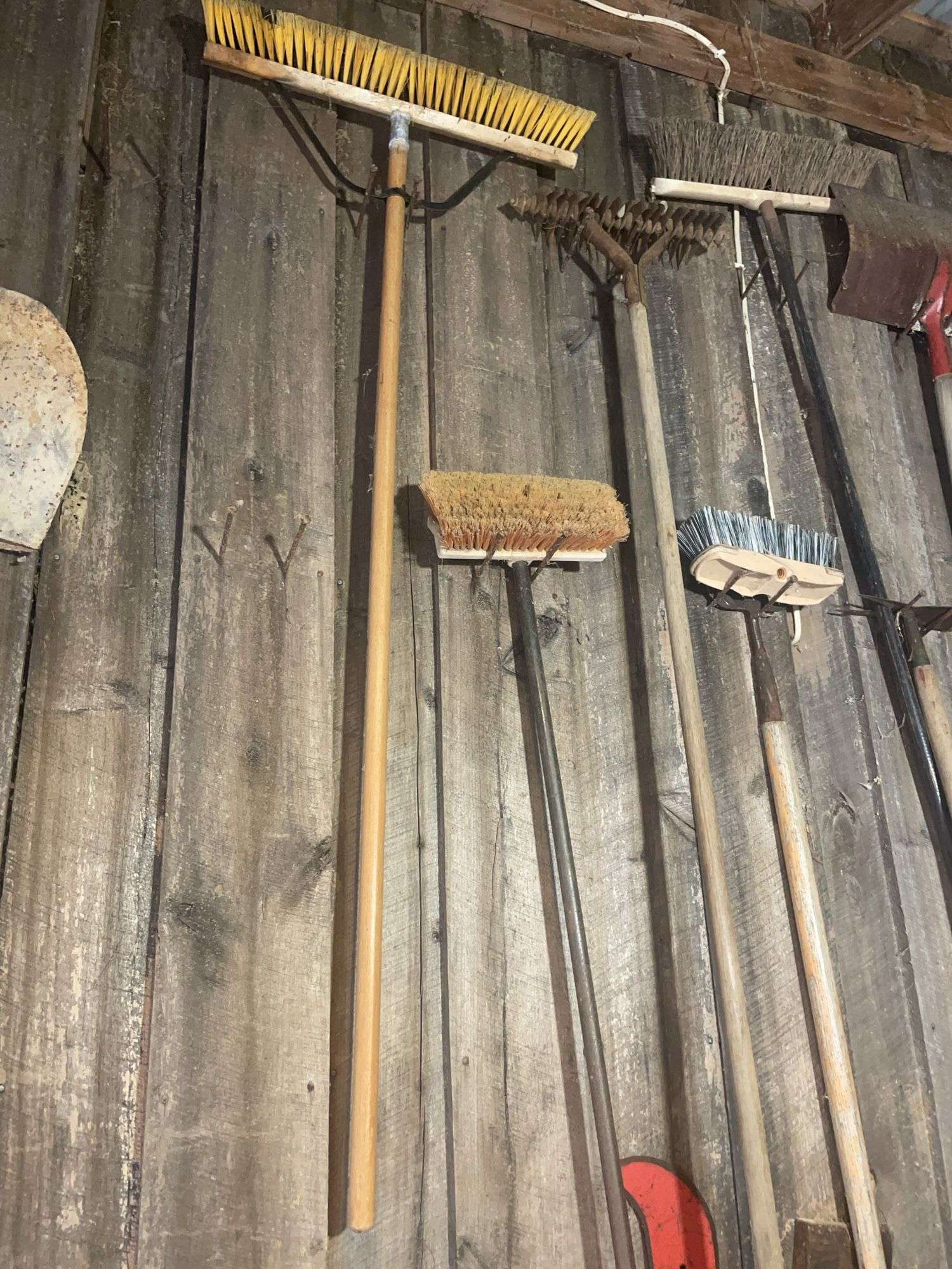 Assortment of brooms, shovel, axe and more - Kaufman Realty & Auctions