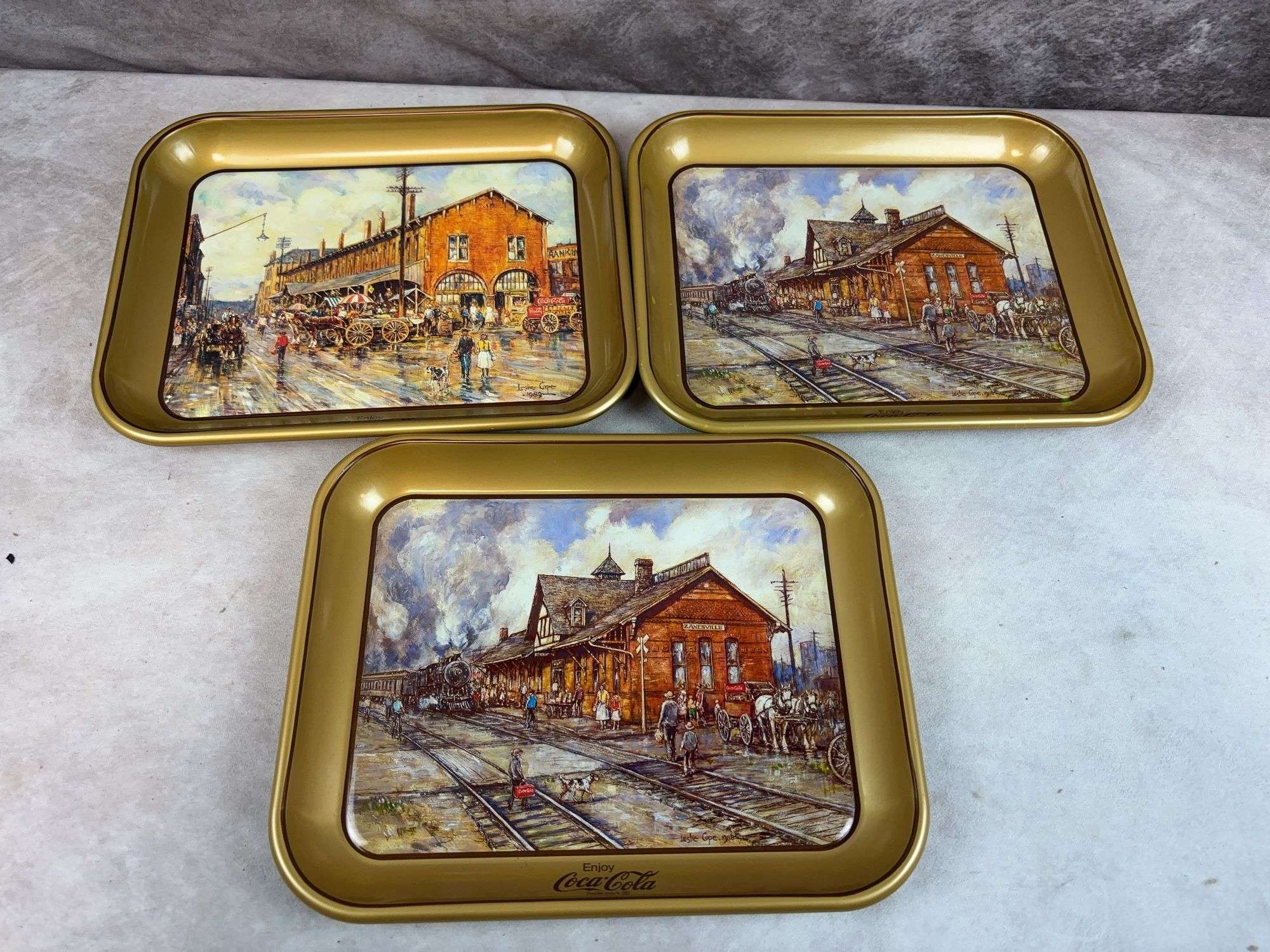 3 gold-bordered Coca-Cola trays with 1989 Lyndon Gage train station and ...